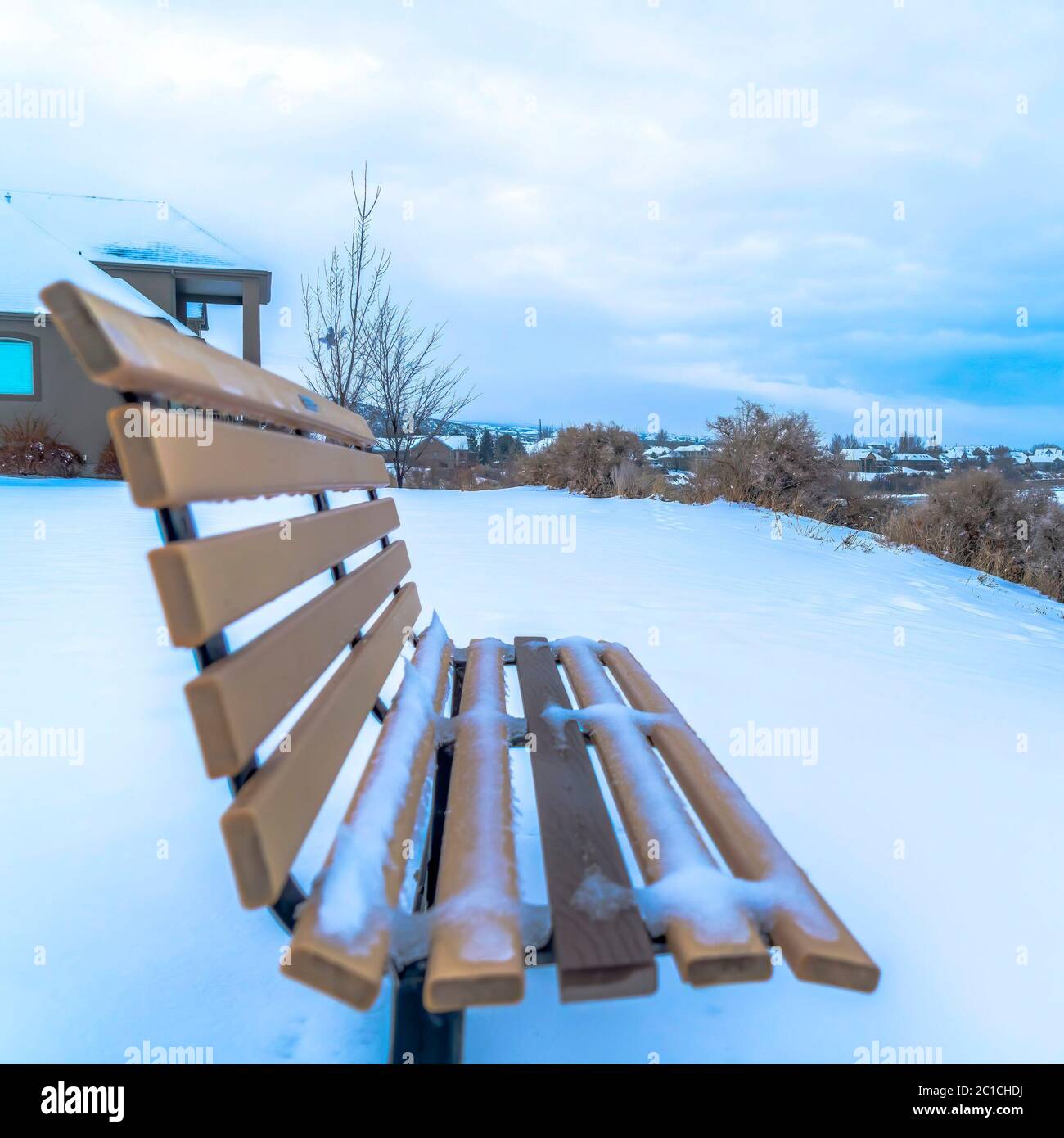 Square Empty frosted bench on snow covering the land in winter ...