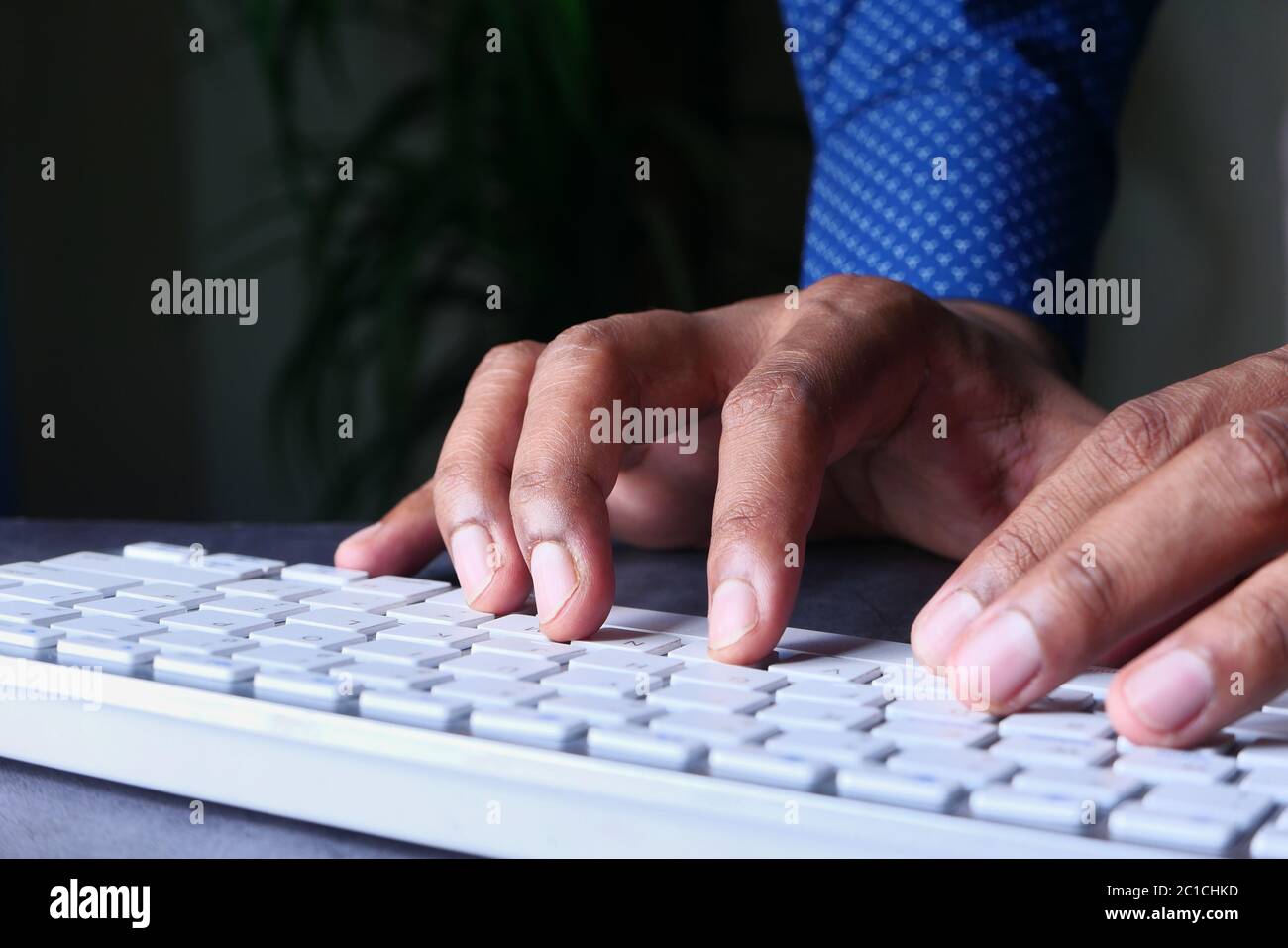 young man typing on keyboard at office desk Stock Photo - Alamy