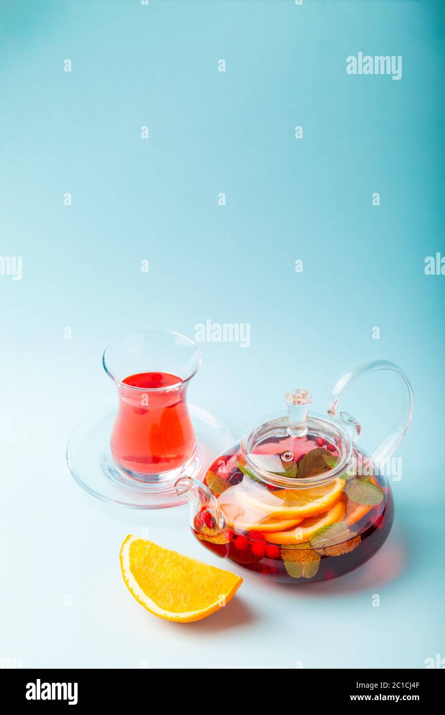 Fruit tea with berries in kettle, turkish shape tea cup Stock Photo - Alamy