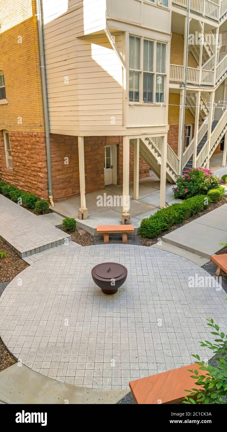 Vertical frame Fire pit outside a residential building with white ...