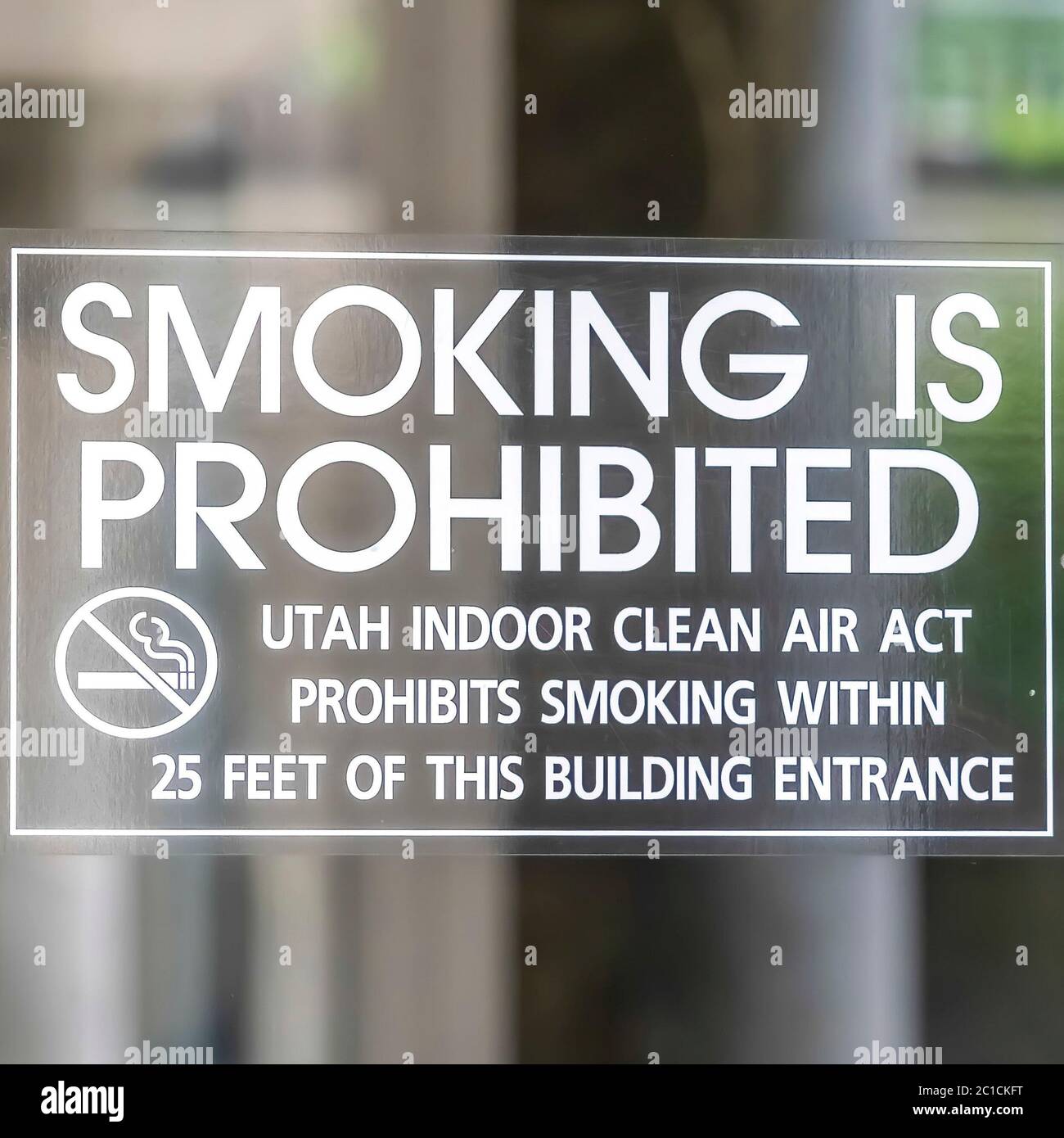 Square Smoking is Prohibited sign close up on clear glass door of ...