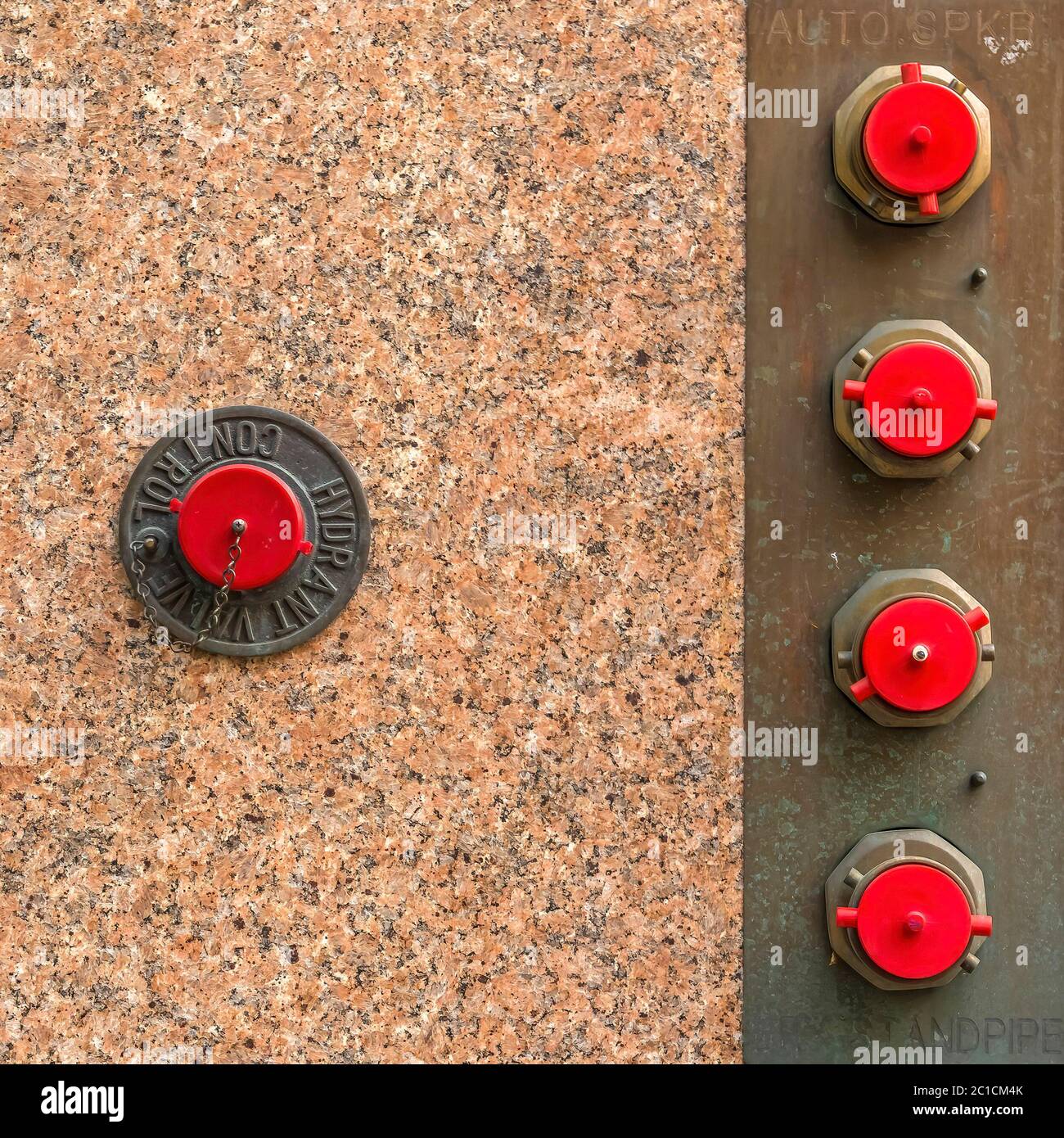 Square Close up of fire hydrant valve control against the exterior wall ...