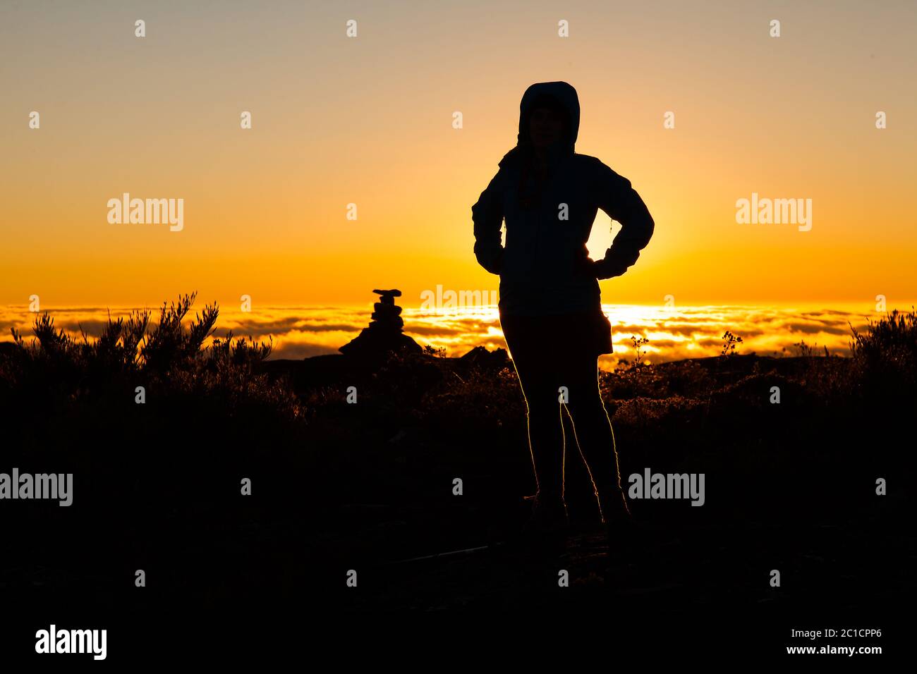 Silhouette girl in backlight on mountain summit at sunset Stock Photo ...