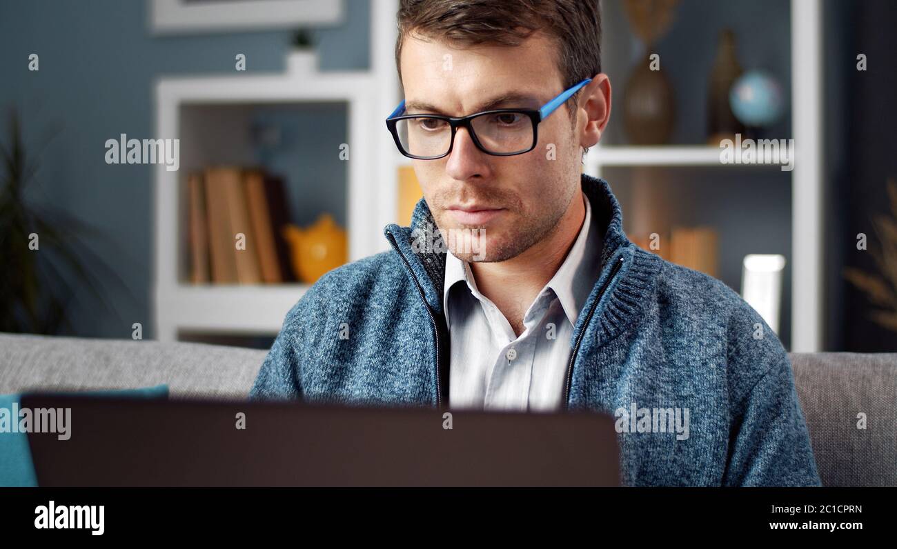 Focused man using laptop Stock Photo - Alamy