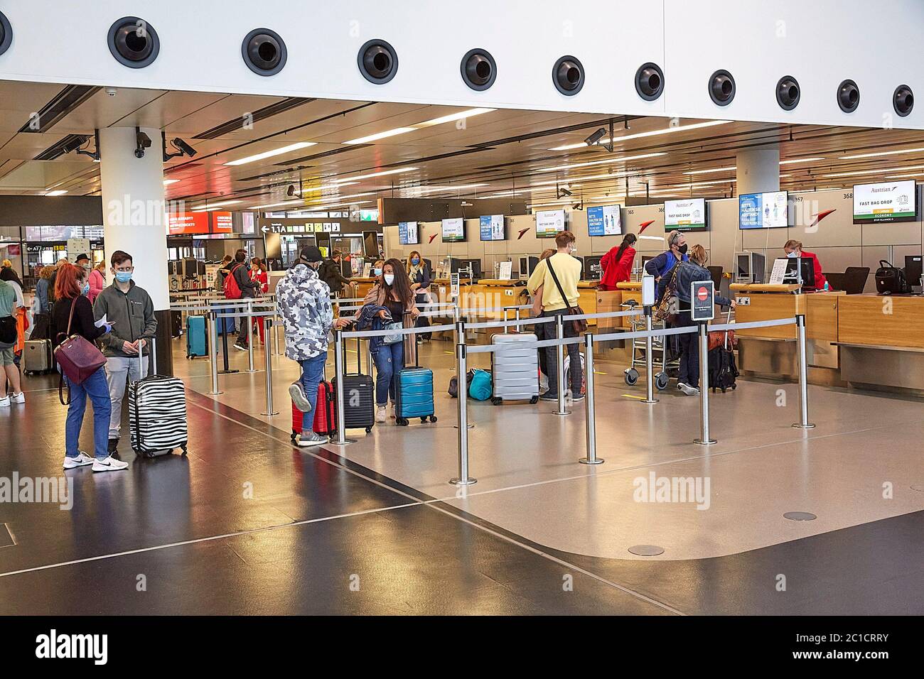 Vienna, Austria. 15th June, 2020. Passengers line up to check in at the ...