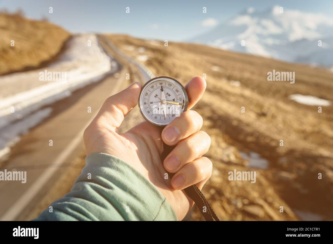 Compass in Hand mountain road background .Vintage Tone Stock Photo - Alamy