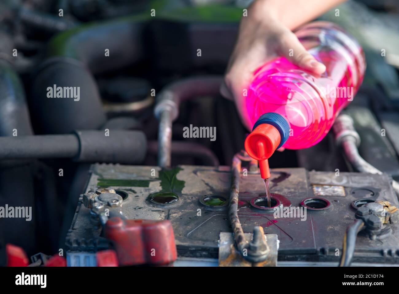 Hand on Add distilled water battery Concept to maintain and maintain ...
