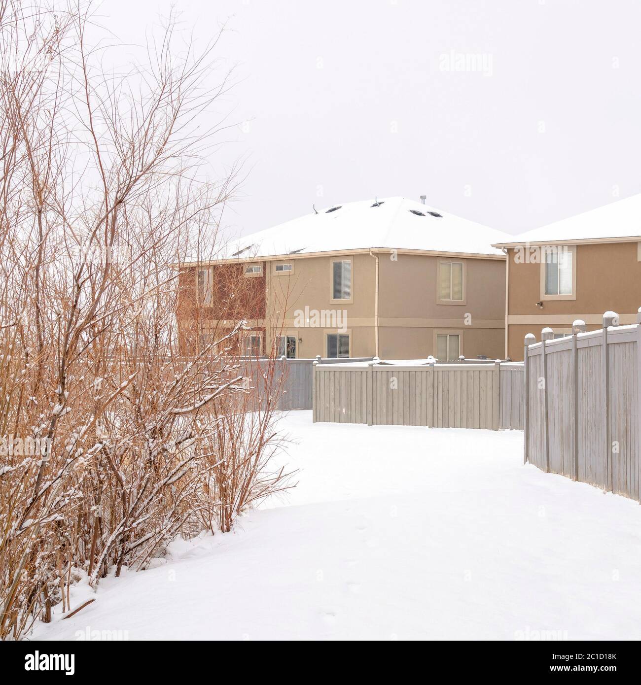 Square Exterior view of homes with snow covered ground in front of ...