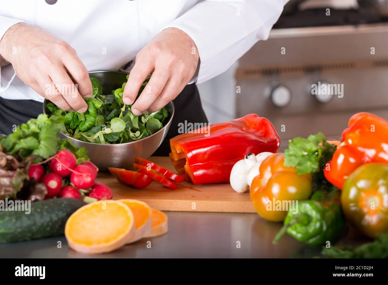Male chef cutting lettuce hi-res stock photography and images - Alamy
