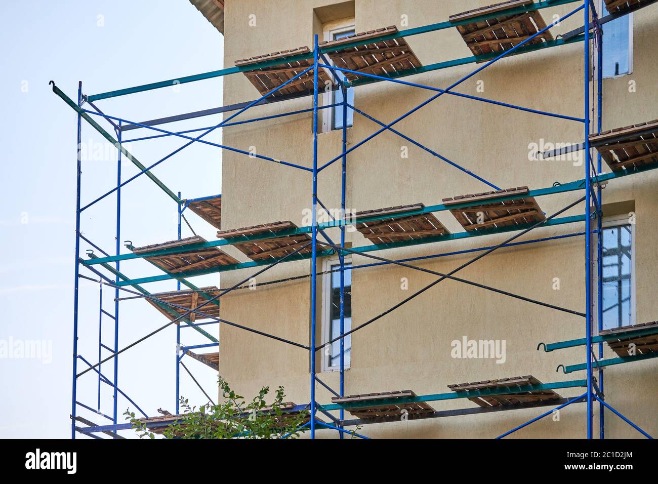 Scaffolding on construction site. Incomplete building and decoration ...