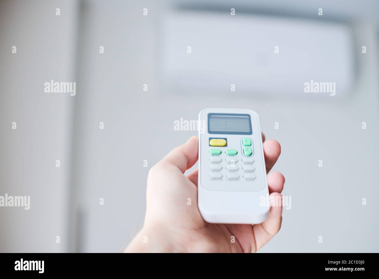 Air condition remote control. Hand with room conditioner remote control ...