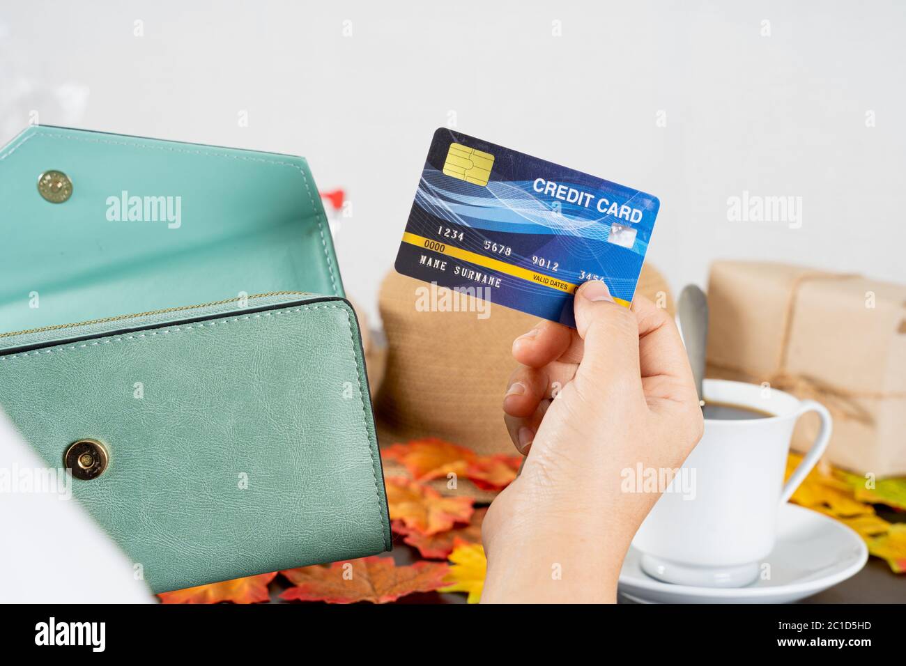 Women hand Using a blue credit card, she pulled the card out of her ...