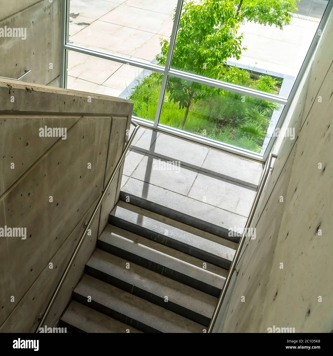Square crop Commercial building interior with staircase and handrails ...