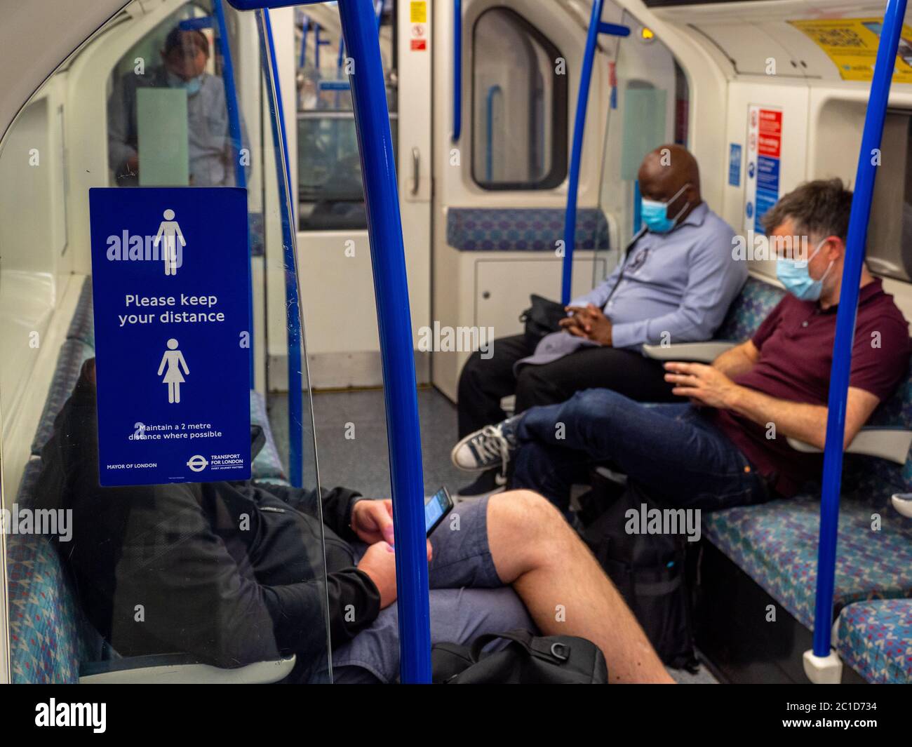 Social distancing measures on a London Underground tube train Stock ...