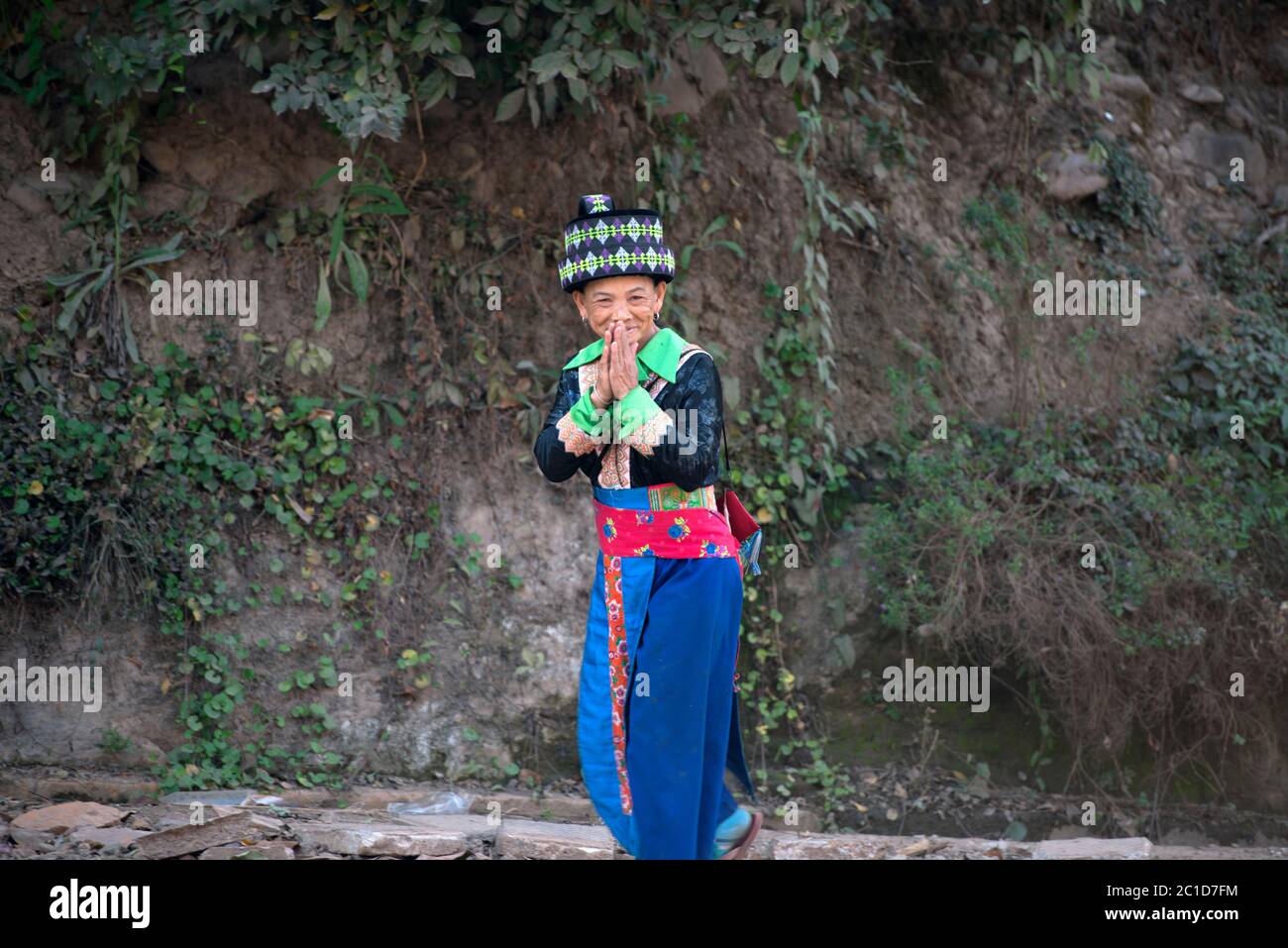 An elderly, indigenous, ethnic Hmong lady walking in Luang Namtha ...