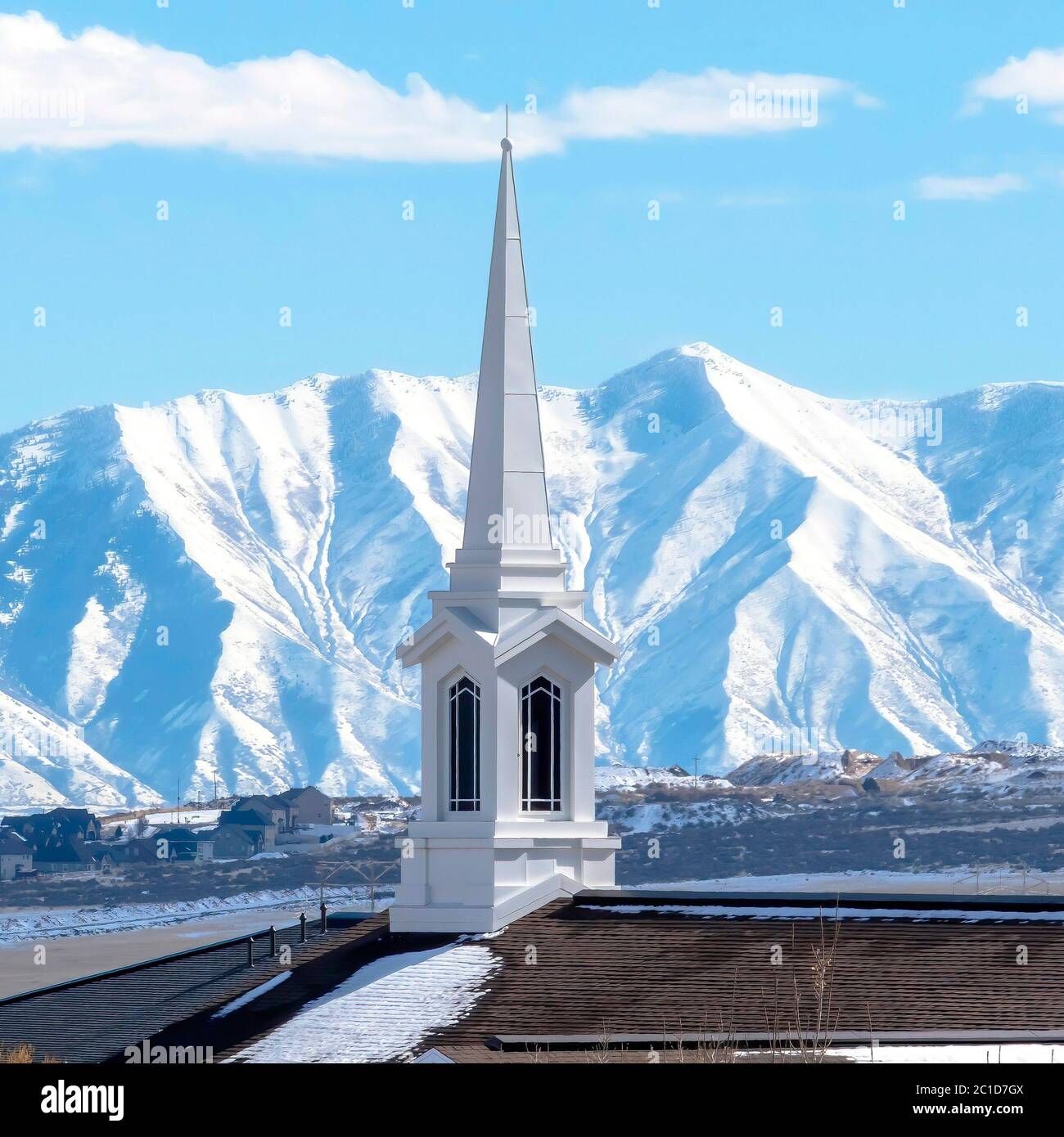 Square frame Modern spires of church with steep snowy mountain and ...