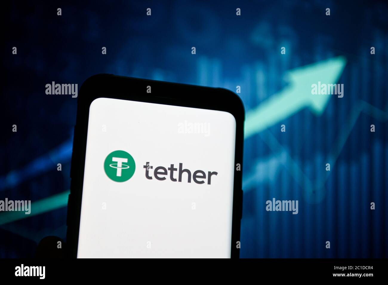 In this photo illustration a Tether logo seen displayed on a smartphone ...