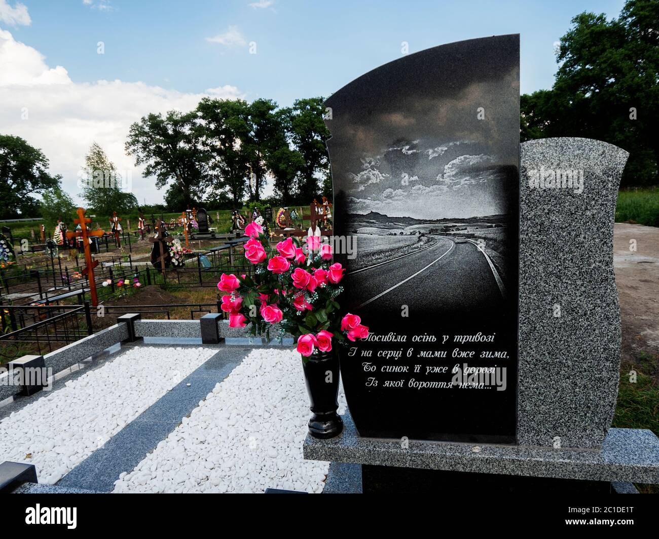 A monument with landscape engraved on black marble on a grave in an ...