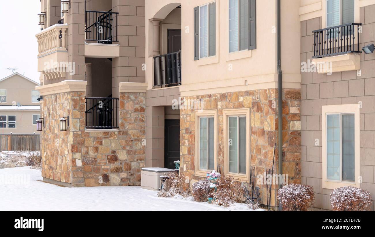 Panorama crop Residential apartment building facade with snow covered ...