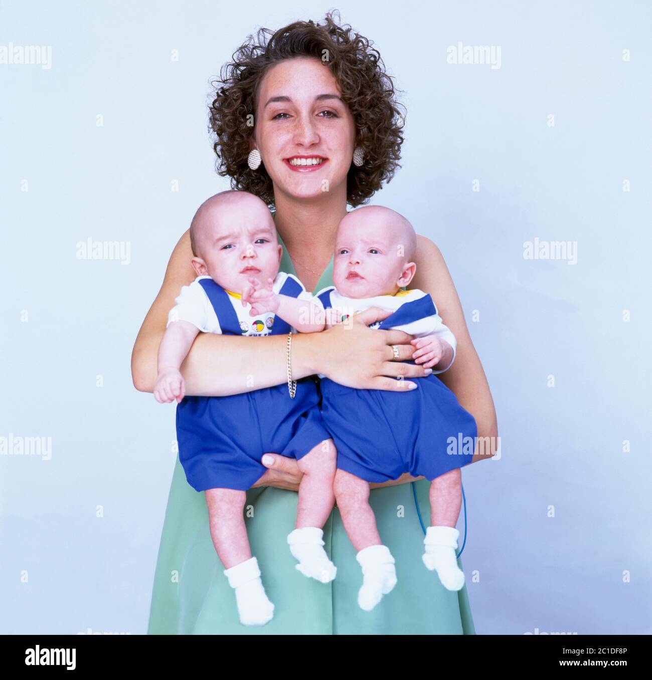 Mother with her twin babies Stock Photo - Alamy