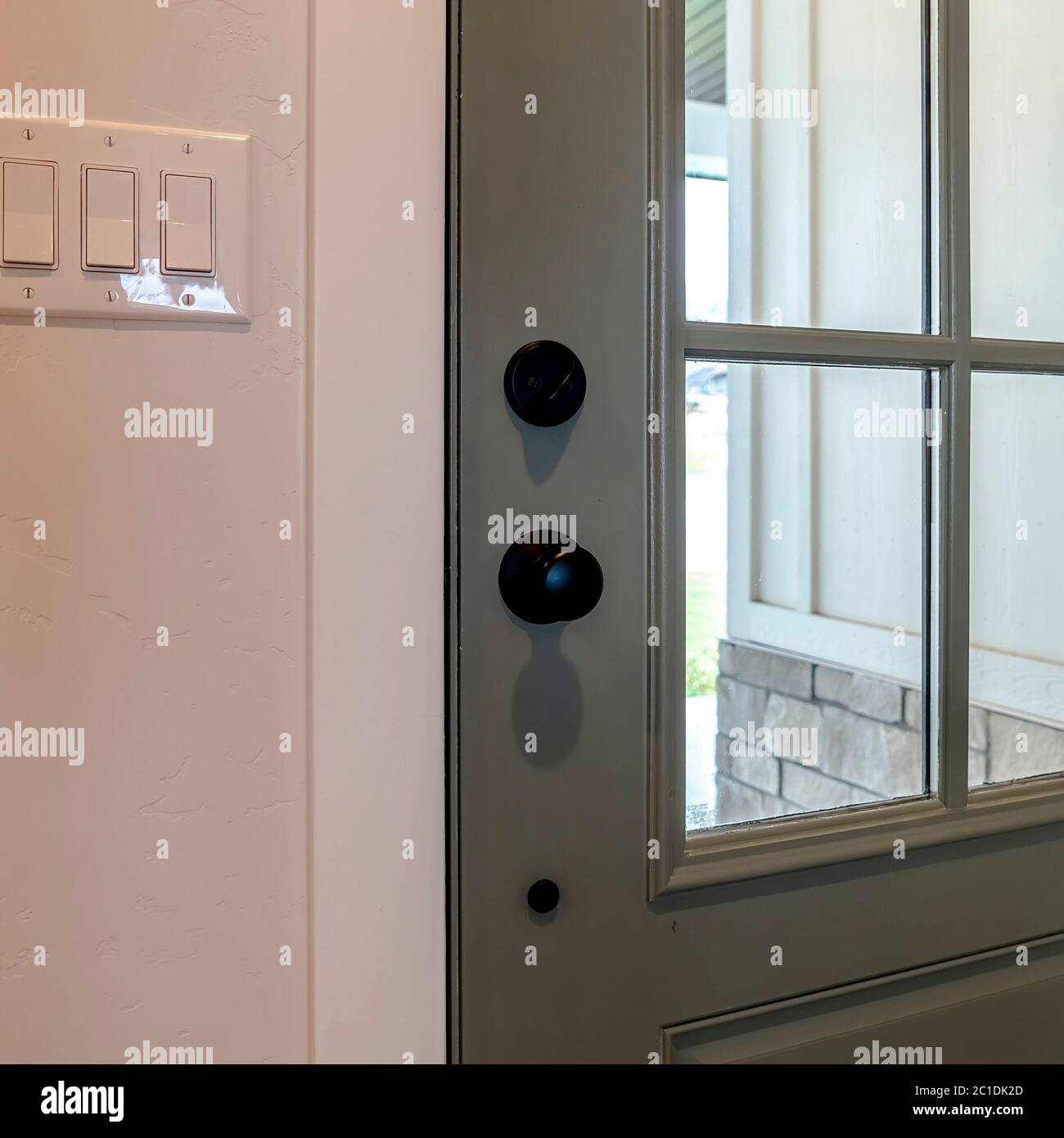 Square frame Close up of wooden front door of home with glass panel and ...