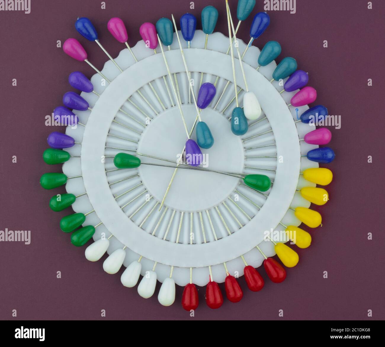 Some various colored brooches pin placed on top of a full set of ...