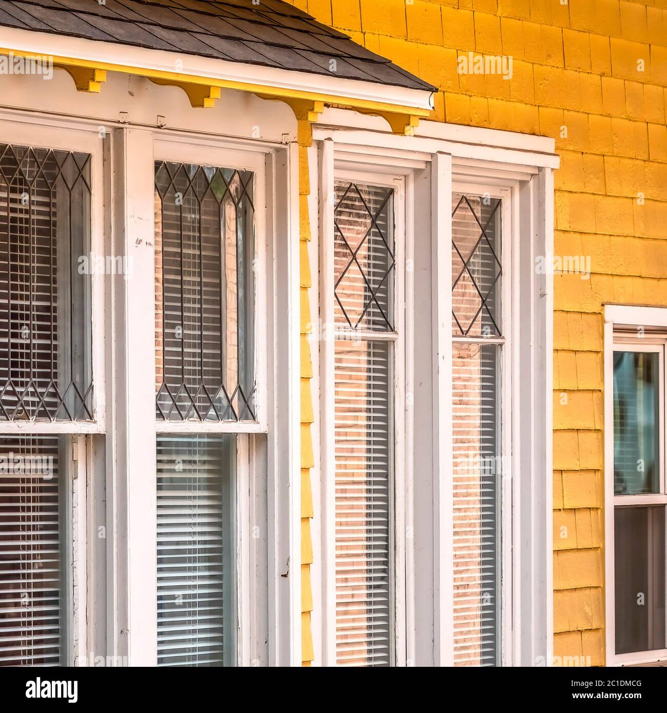 Square crop Building exterior with yellow wall cladding and awning over ...