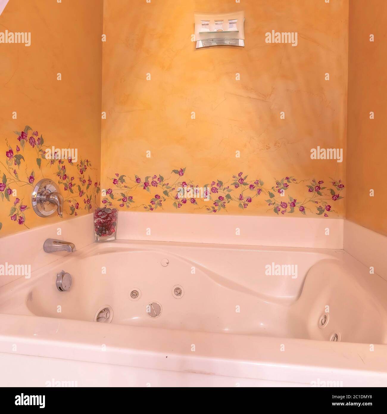 Square crop Built in white jacuzzi tub inside a bathroom with flower ...