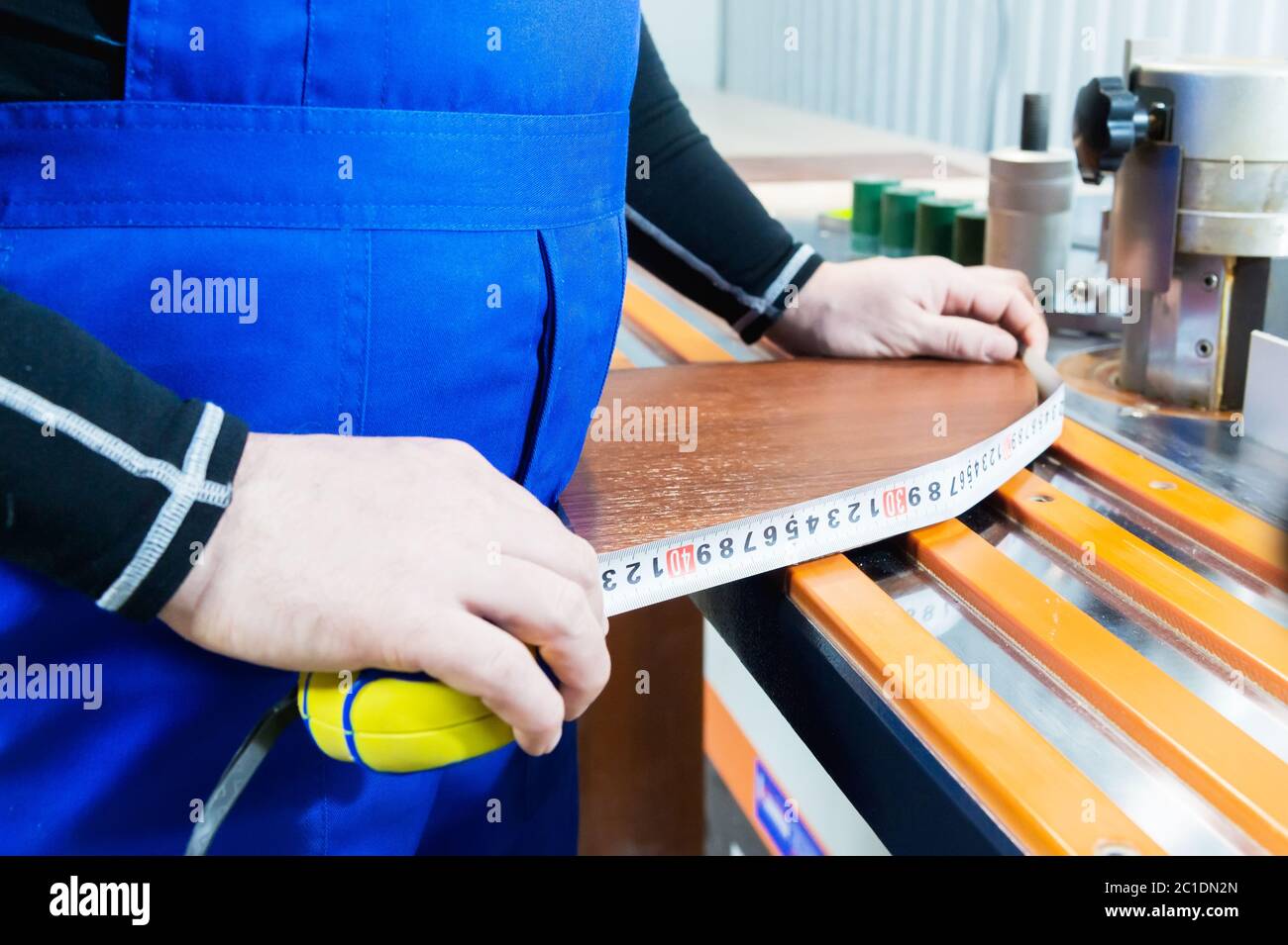 Closeup of Carpenter's hands using one meter in a cottage workshop ...