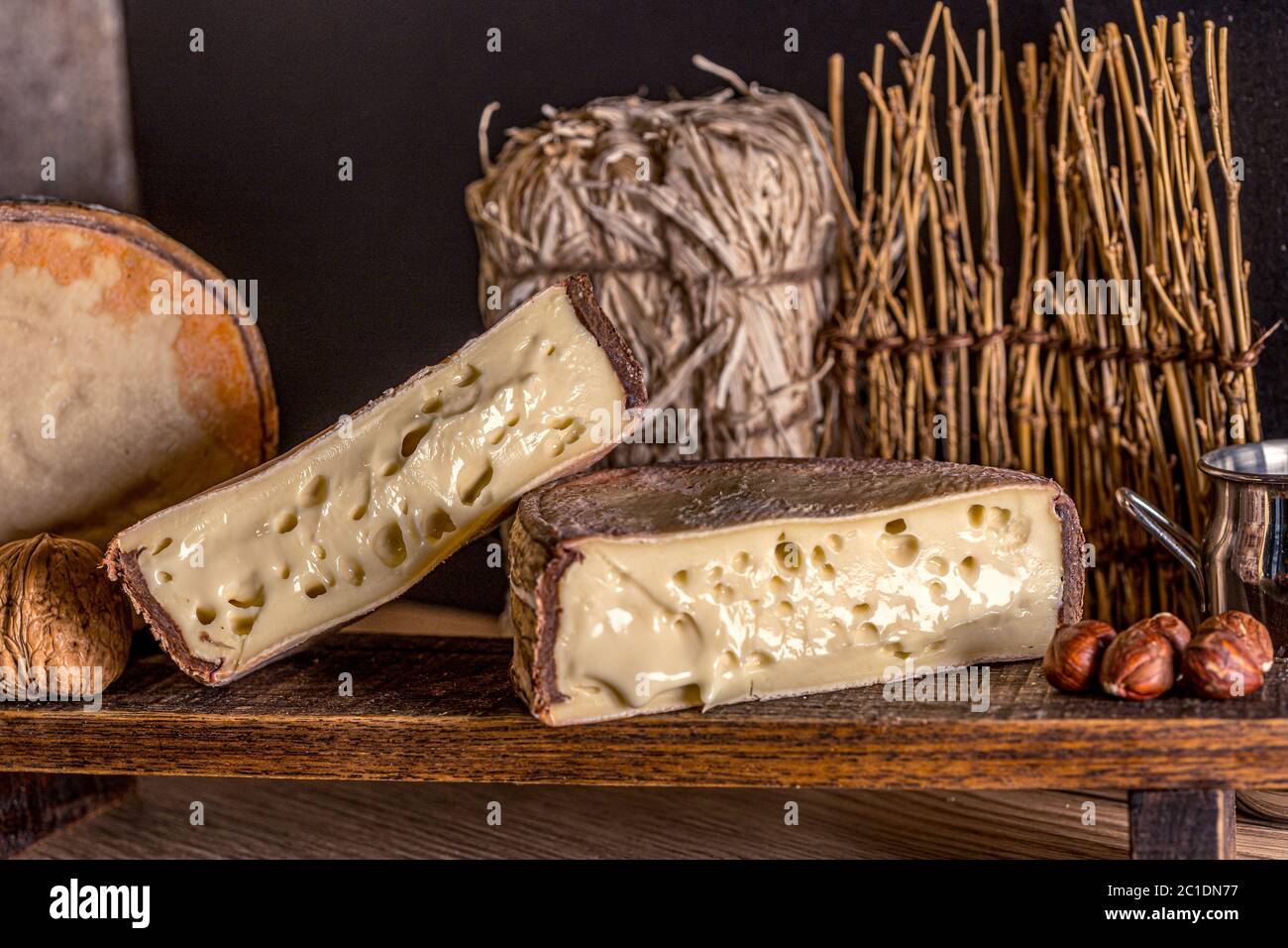 French cheese Saint Nectaire rustic collection delicious. Black ...