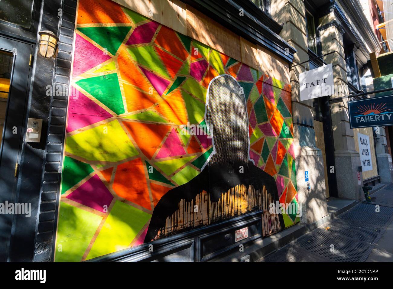 Artists draw Portrait of Jorge Floyd on the Barricade Board of stores ...