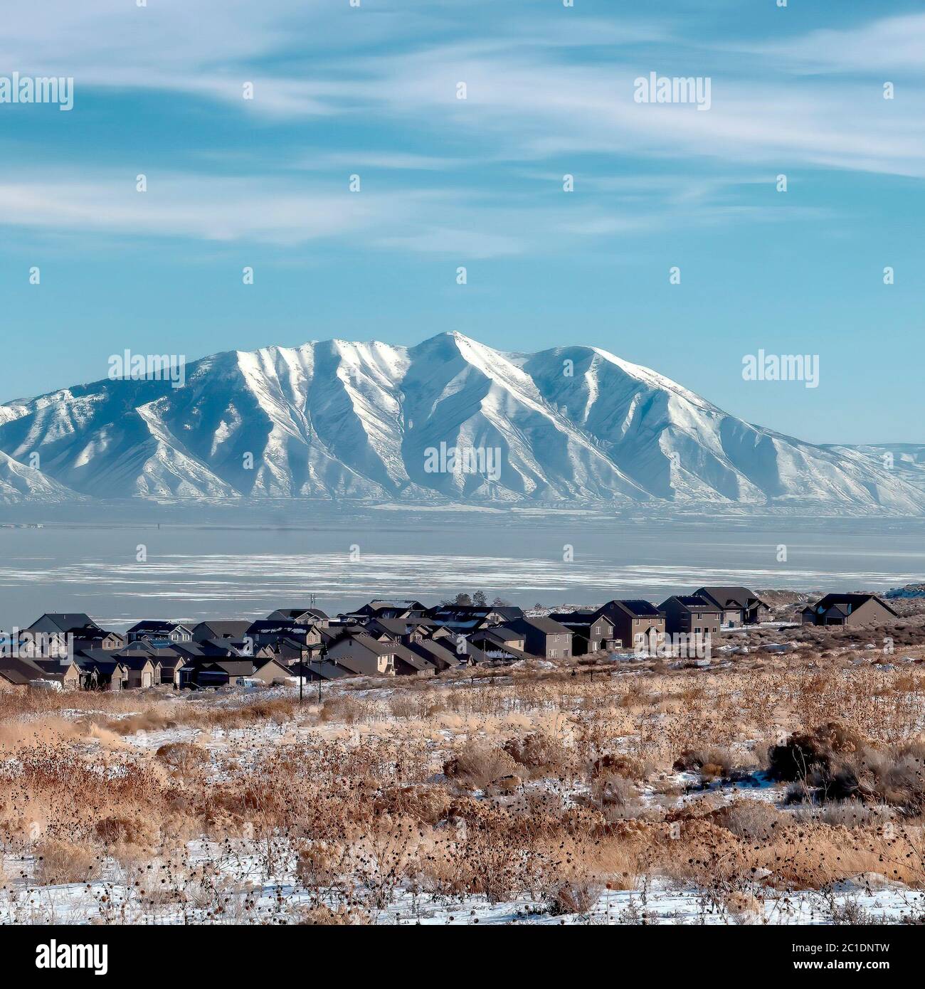 Square frame Rugged Wasatch Mountains and icy Utah Lake with snowy ...