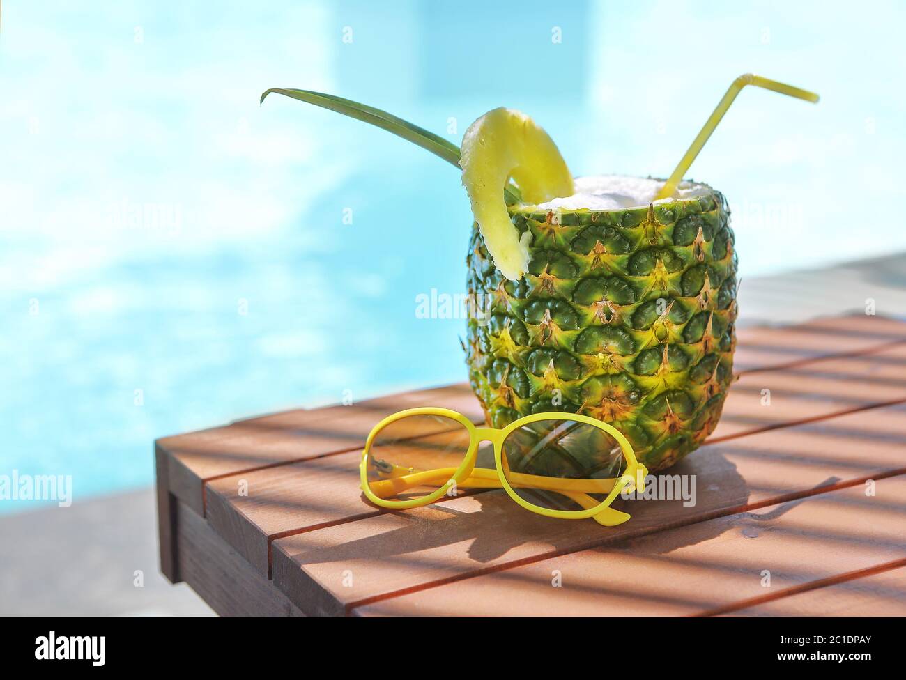 Exotic pineapple cocktail near pool. Pina colada Stock Photo - Alamy