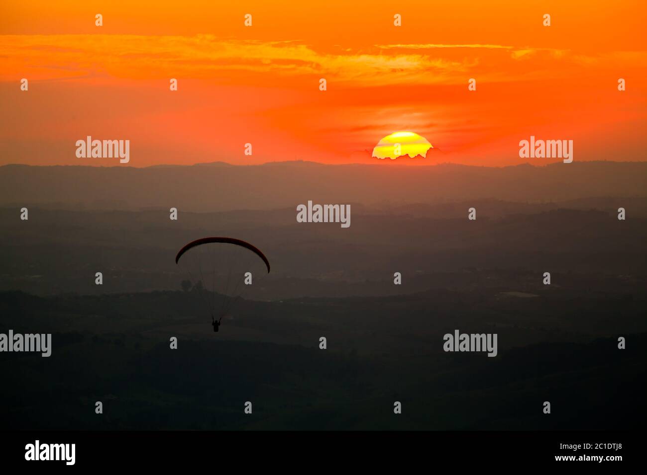 Paragliding in sunset Stock Photo - Alamy