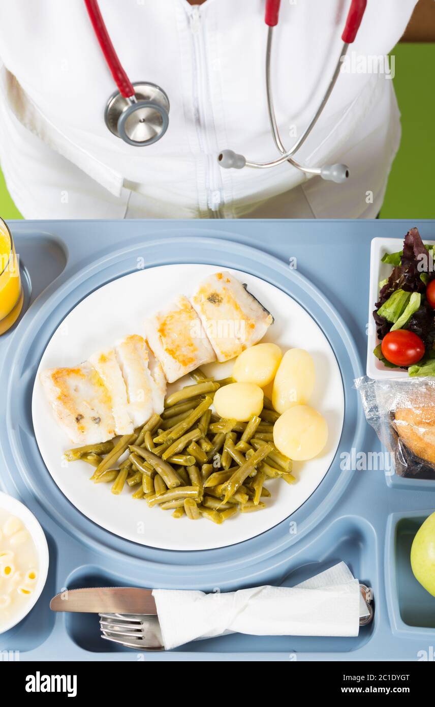 Health professional with a tray of food to a patient Stock Photo - Alamy