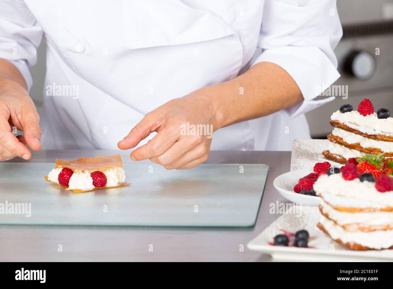 Pastry chef finishing a delicious puff pastry Stock Photo - Alamy