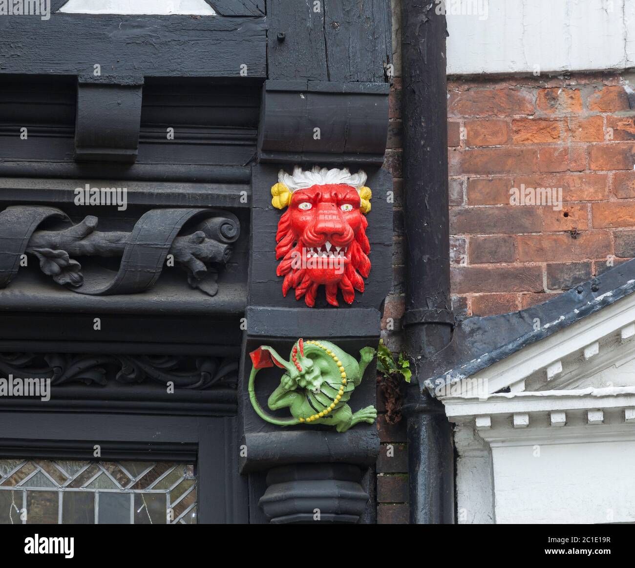Carved wooden red lion and green dragon on the outside of a house in ...