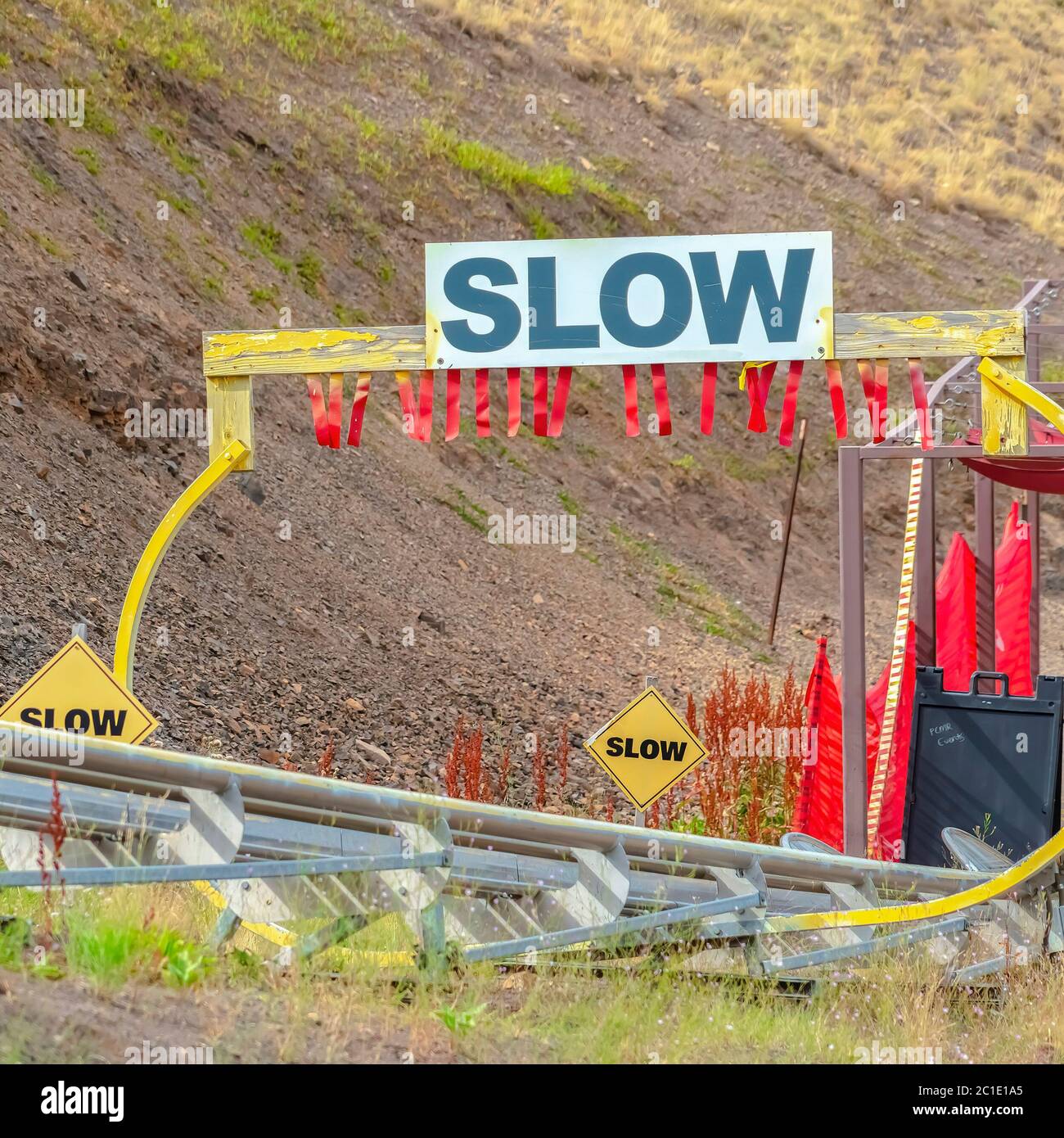 Square frame Coaster attraction with Slow safety signs in Park City ...