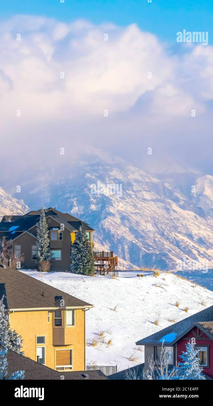 Vertical Beautiful mountain homes against snowy Wasatch peaks and ...