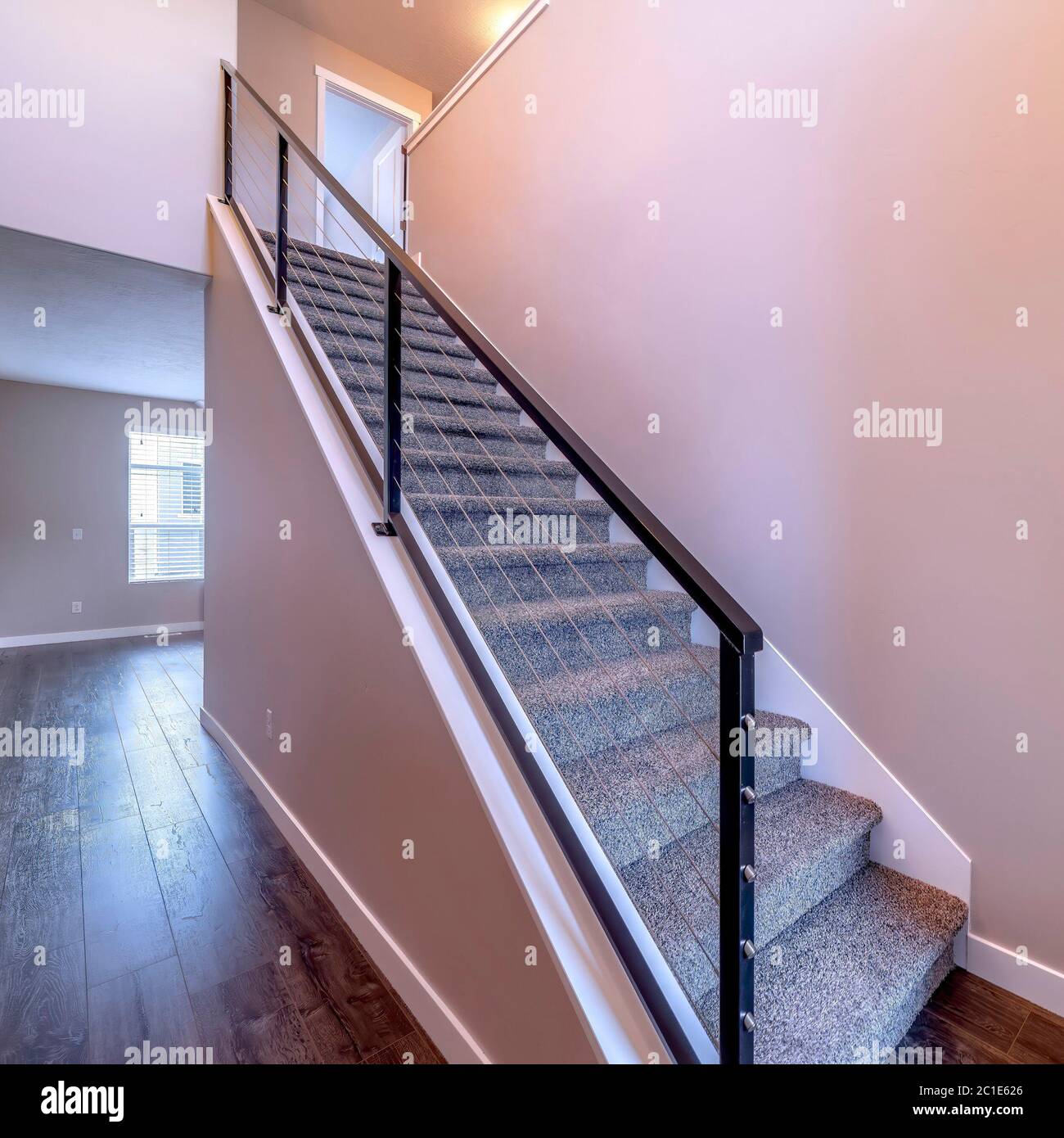 Square Indoor staircase against brown wooden floor and plain white wall ...