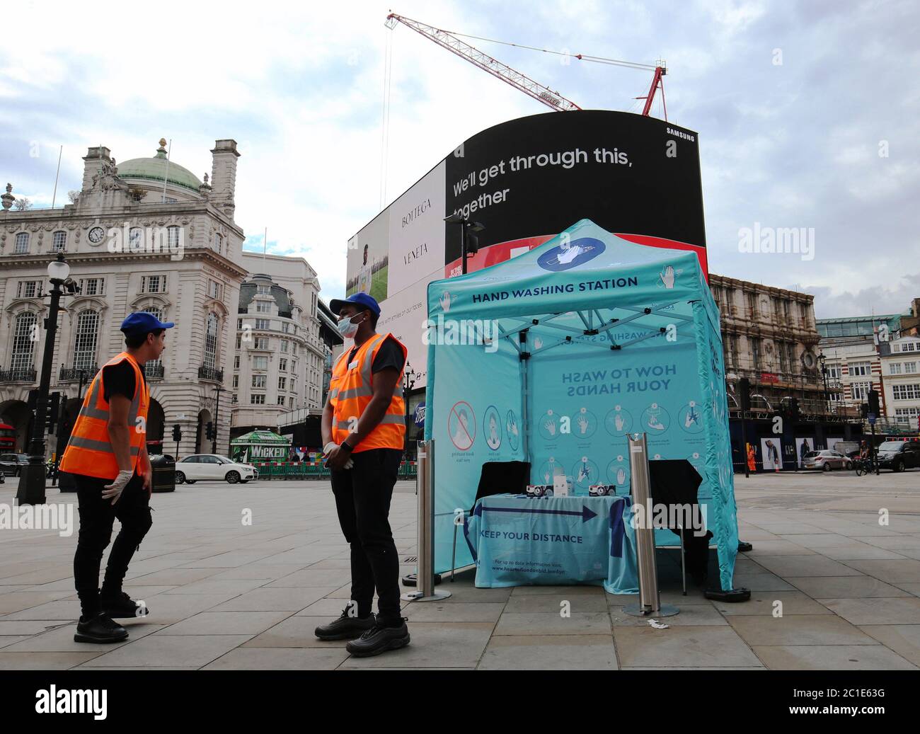 Social distancing ambassadors man a pop up hand washing station in ...