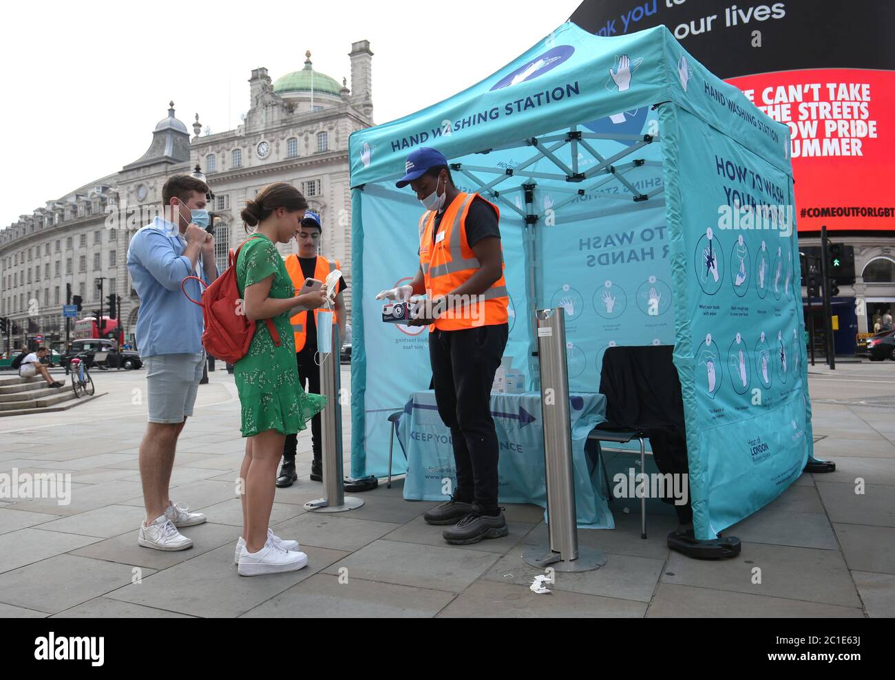 Social distancing ambassadors man a pop up hand washing station in ...