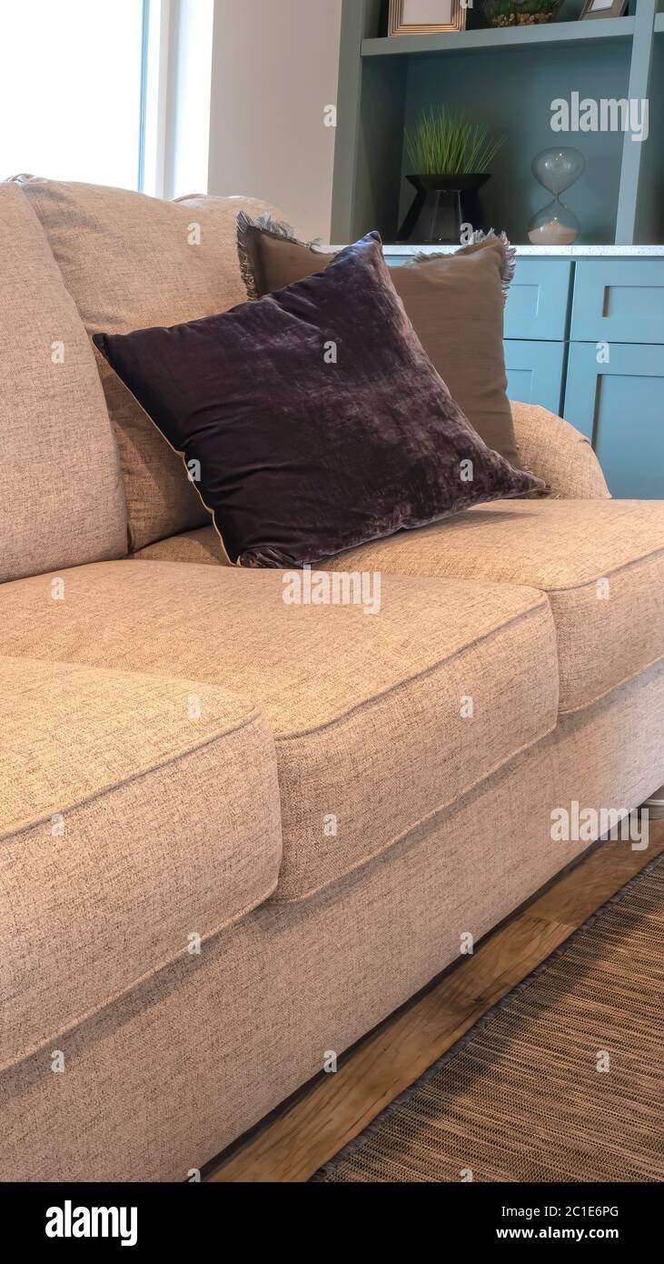 Vertical Living room interior with close up of cozy sofa against window ...