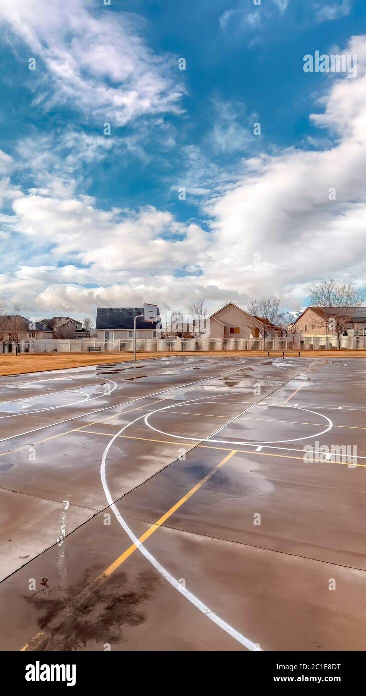 Vertical Basketball courts on grassy park with residential neighborhood ...