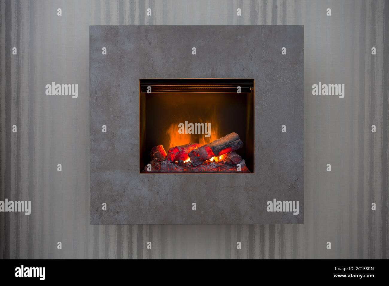 Detail shot of a modern simple fireplace with grey wall Stock Photo - Alamy
