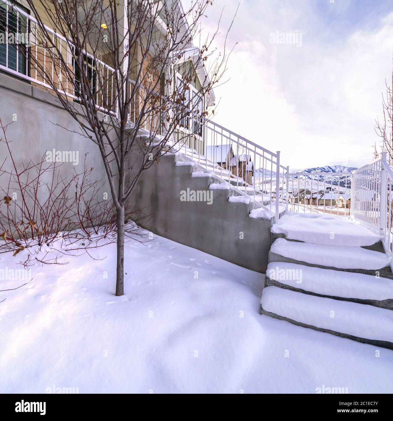 Square frame Snow covered concrete exterior entrance steps day light ...
