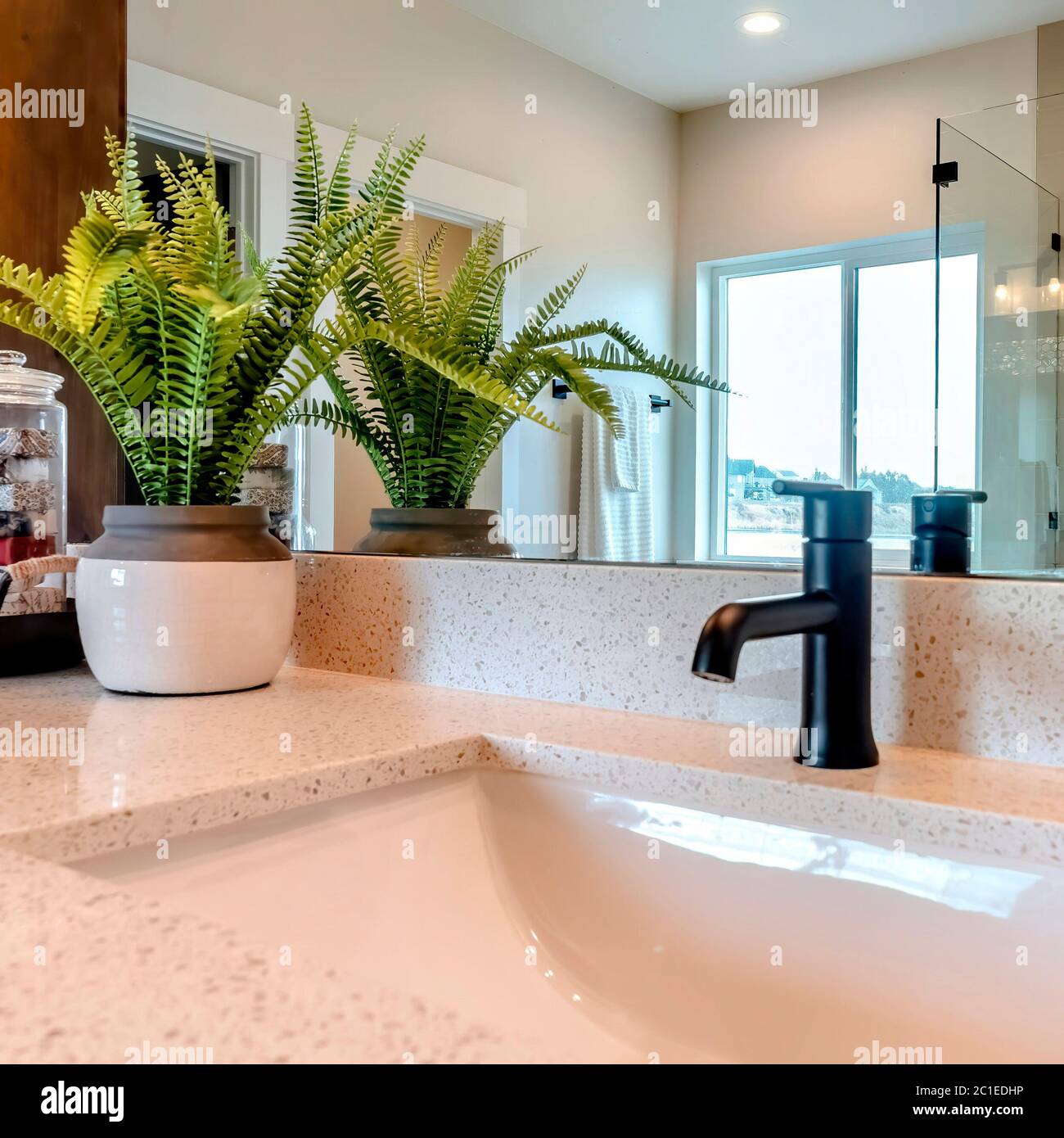 Square Sink and faucet against mirror that reflects shower stall and ...