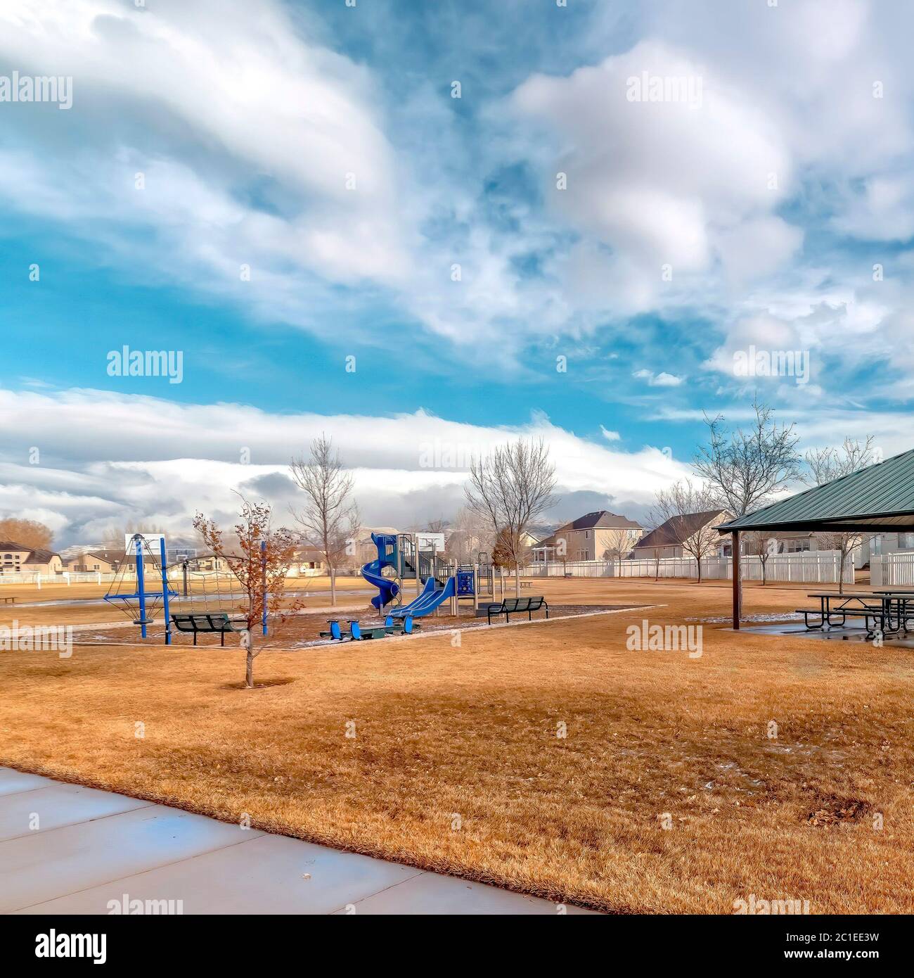 Square Park scenery with pathway along pavilion and playground with ...