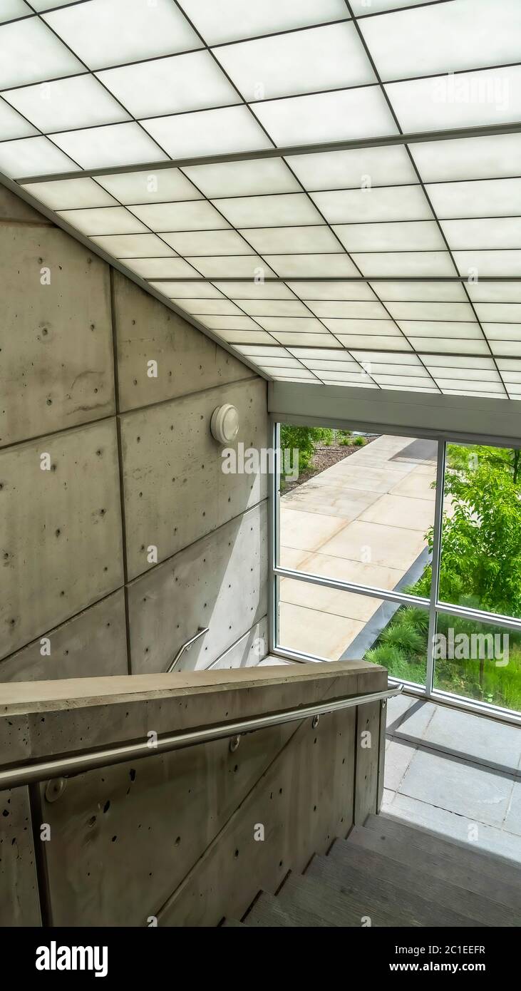 Vertical frame Commercial building interior with slanted frosted glass ...