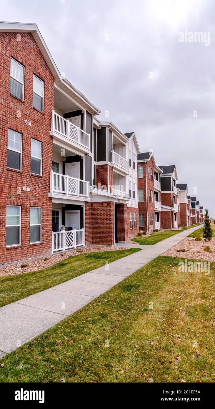 Vertical Modern brick apartment complex with balconies day light Stock ...